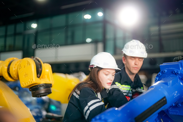 Engineer testing a robotic production simulator in robotics research ...