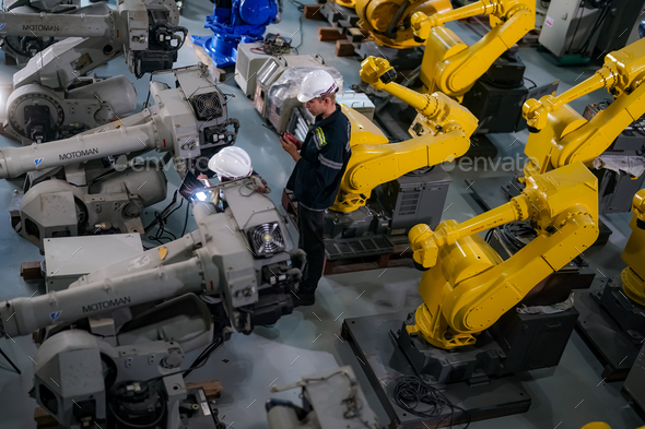 Engineer testing a robotic production simulator in robotics research ...