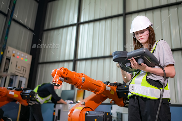 Engineer testing a robotic production simulator in robotics research ...