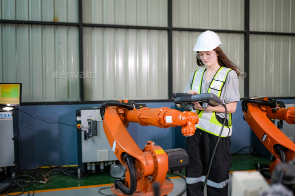 Engineer testing a robotic production simulator in robotics research ...