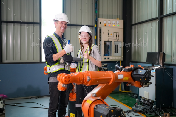 Engineer testing a robotic production simulator in robotics research ...