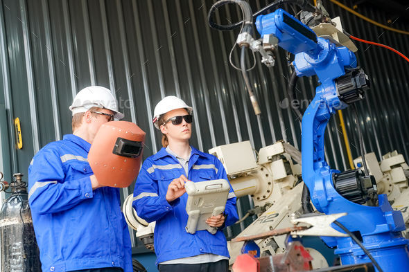 Engineer testing a robotic production simulator in robotics research ...