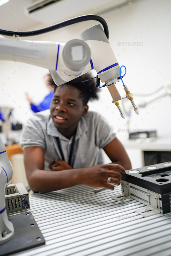 Robotic Arm engineer check on equipment in its with software of ...