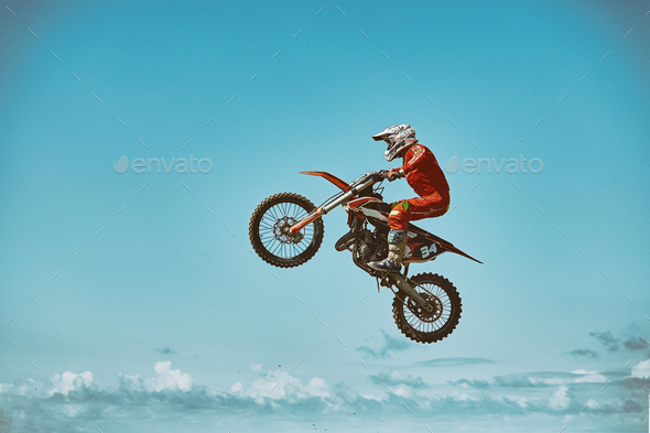 Extreme sports, motorcycle jumping. Motorcyclist makes an extreme jump ...