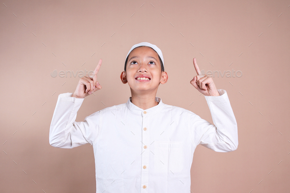 Muslim Boy Pointing and Looking Up for Ramadan and Eid Advertisement ...
