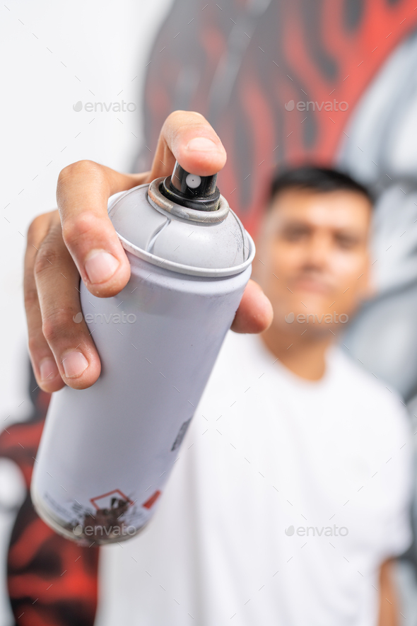 Finger of a muralist pressing a paint spray Stock Photo by GSR-PhotoStudio