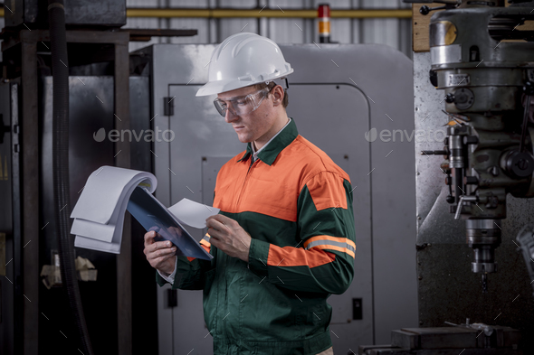 Industry engineer wearing safety uniform control operating lathe ...