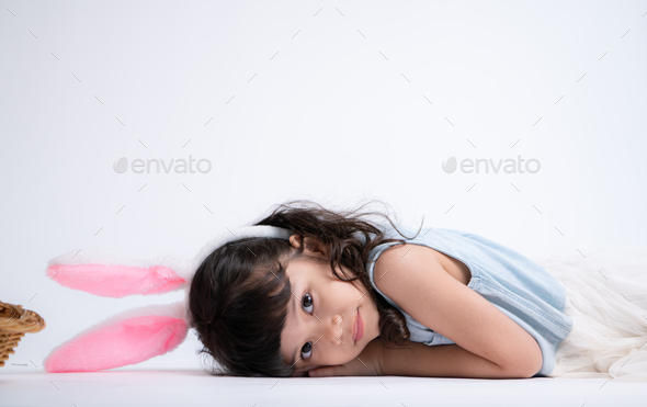 Smiling little girl and with their beloved fluffy rabbit, showcasing ...