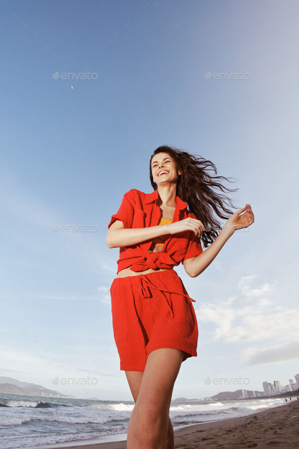 Sun-Kissed Summer Vibes: Joyful Woman Dancing Freely on the Beach ...