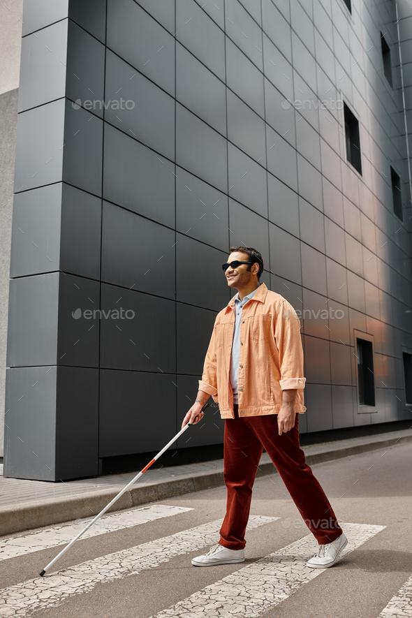 joyful indian blind man in orange jacket with walking stick and glasses ...