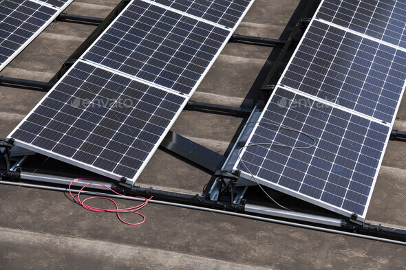 A closeup of solar panels with visible wiring on a rooftop. Stock Photo ...