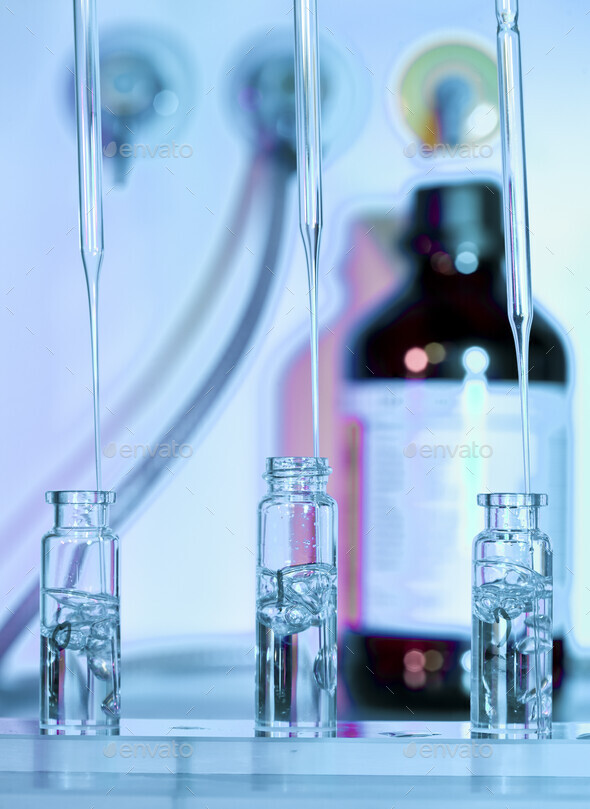 Science in action with pipettes dispensing liquid into test tubes Stock ...