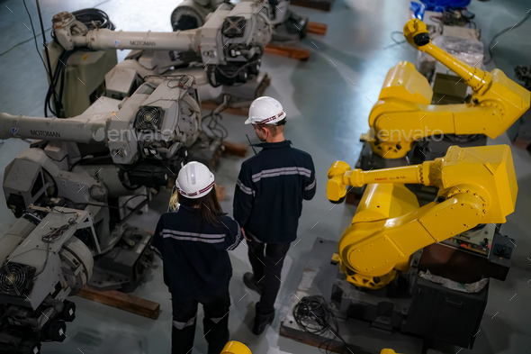 Engineer testing a robotic production simulator in robotics research ...