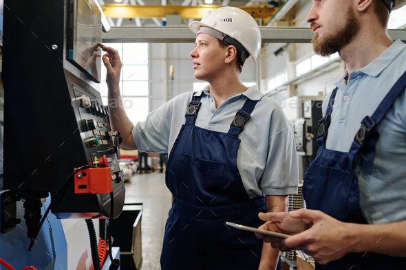 Factory Workers Using CNC Machine Stock Photo by AnnaStills | PhotoDune