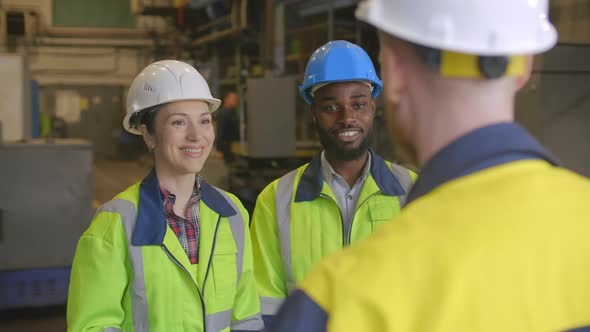 Three Multiracial Engineers Hugging and Cheering Each Other, Stock Footage