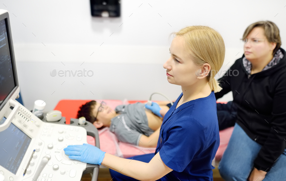 Doctor making abdominal ultrasound for boy using scanner machine. Stock ...
