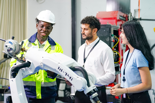 Robotic Arm engineer check on equipment in its with software of ...