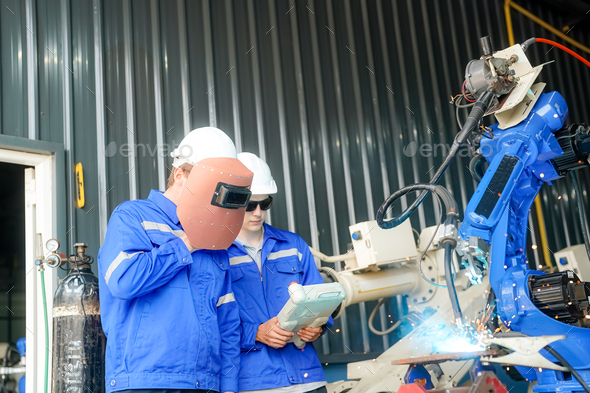 Engineer testing a robotic production simulator in robotics research ...