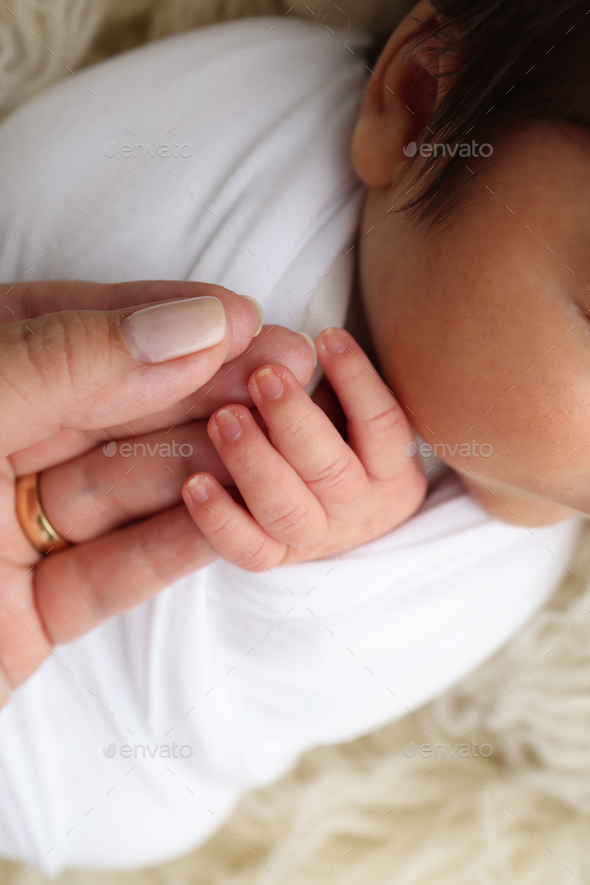 Photo of Newborn baby after birth tightly holding parents finger on ...