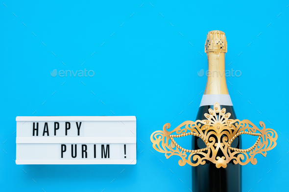 Purim background. Happy Purim written in lightbox, and champagne on a ...