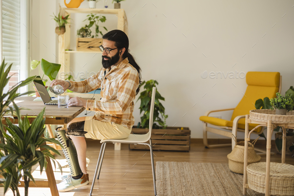 man with computer at home pouring water in a glass Stock Photo by ...