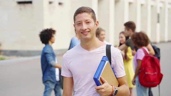 Cheerful Male Student Posing Near College, Stock Footage | VideoHive