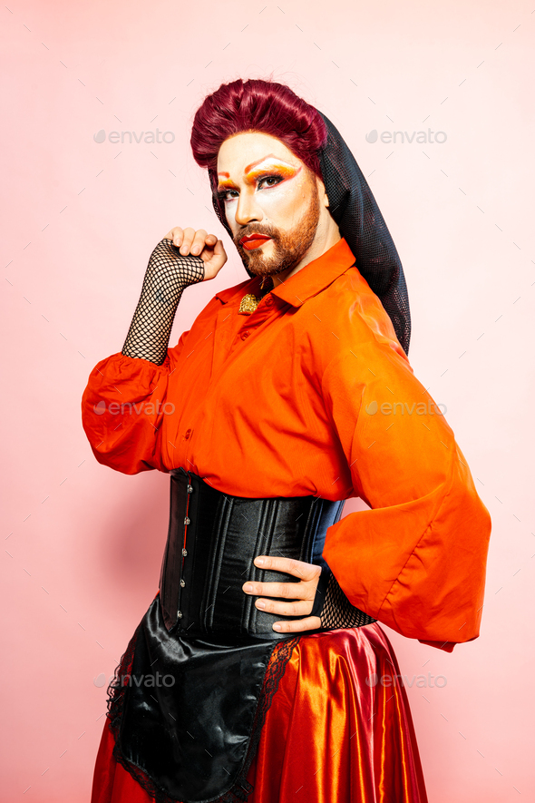 Elegant Drag Queen Poses Confidently in Studio With Pink Backdrop Stock ...