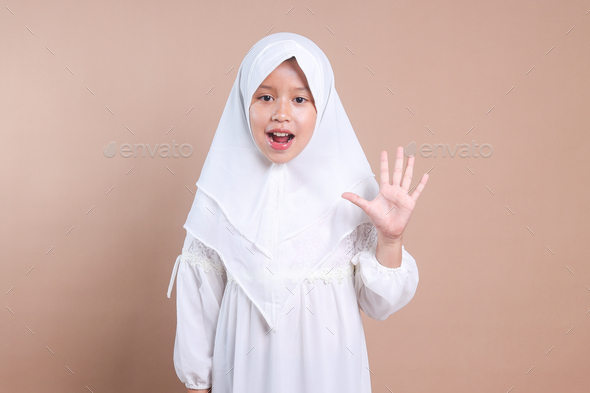 Cheerful Muslim Girl Waving Hand or Showing Number Five Stock Photo by ...