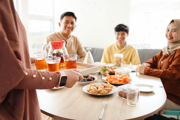 Muslim Woman Serving Drinks to Friends on Iftar Ramadan Stock Photo by ...