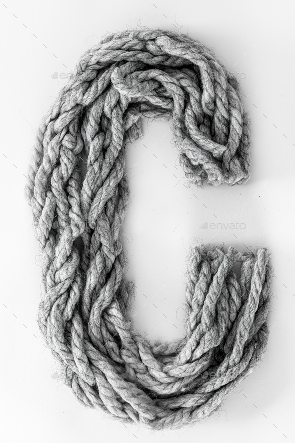 Letter C made from gray threads isolated, top view. Stock Photo by puhimec