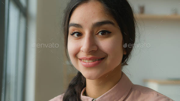 Headshot happy Arabian Indian ethnic millennial woman student girl businesswoman near window ...