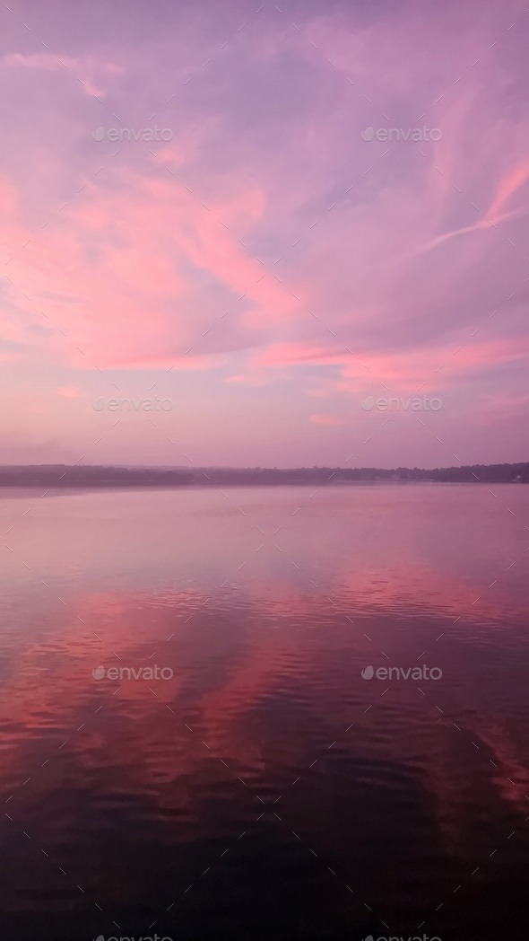 Beautiful pink sunset reflection in the sea Stock Photo by wirestock