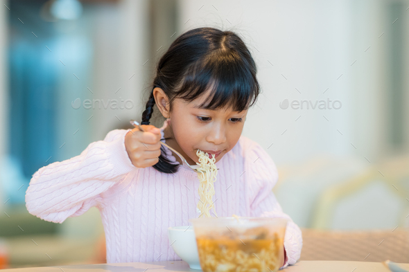 Kid girl eat instant noodles Stock Photo by leungchopan | PhotoDune