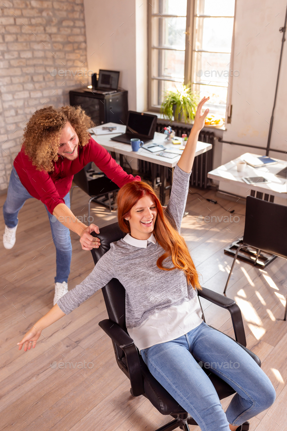 Business people having fun at the office, riding chairs Stock Photo by ...