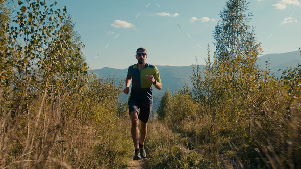 Focused sportive adult Caucasian male man guy runner sprinter jogging ...