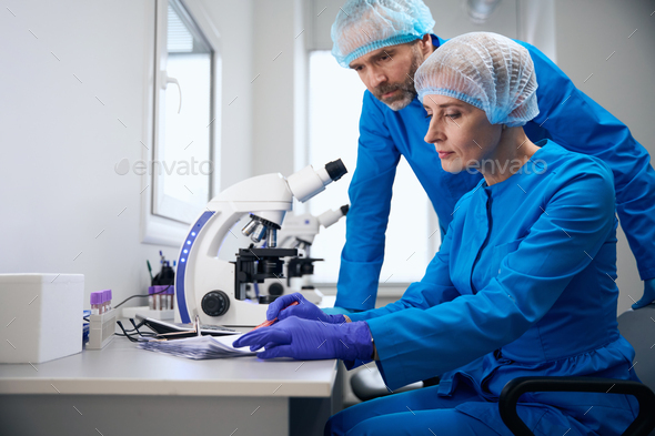People in blue uniforms work in a modern laboratory Stock Photo by ...
