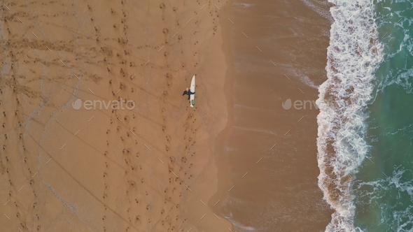 Surfer walking beach sand carrying surfboard top view. Beautiful ocean ...