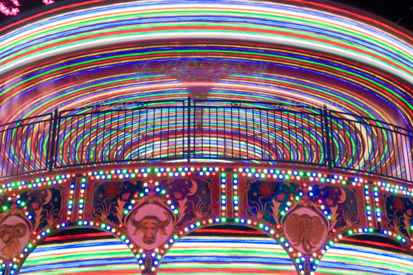 Carnival amusement park ride with swings. Spinning fair ride at night ...