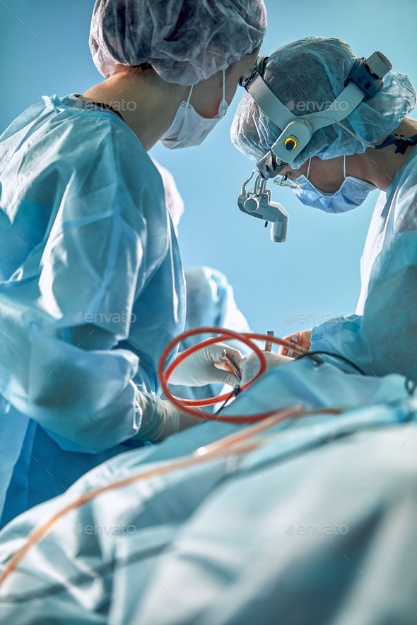 Surgeons team in the operating room, portraits close-up. modern ...