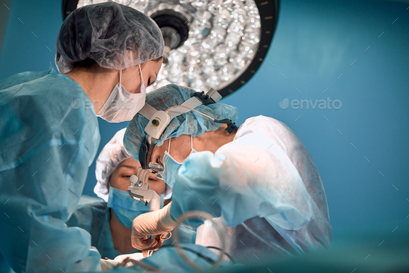 Surgeons team in the operating room, portraits close-up. modern ...