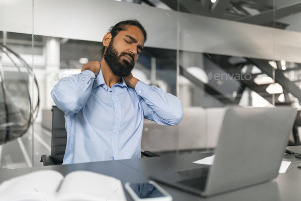 Young indian man employee having strong neck pain or headache Stock ...