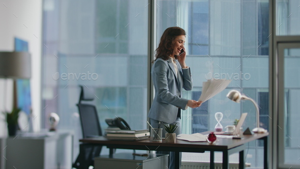 Smiling business woman calling partners at workplace. Happy ceo talking ...