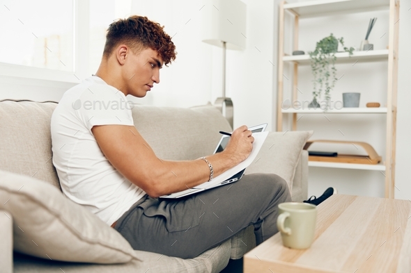 man interior couch person sofa notebook using call looking computer ...