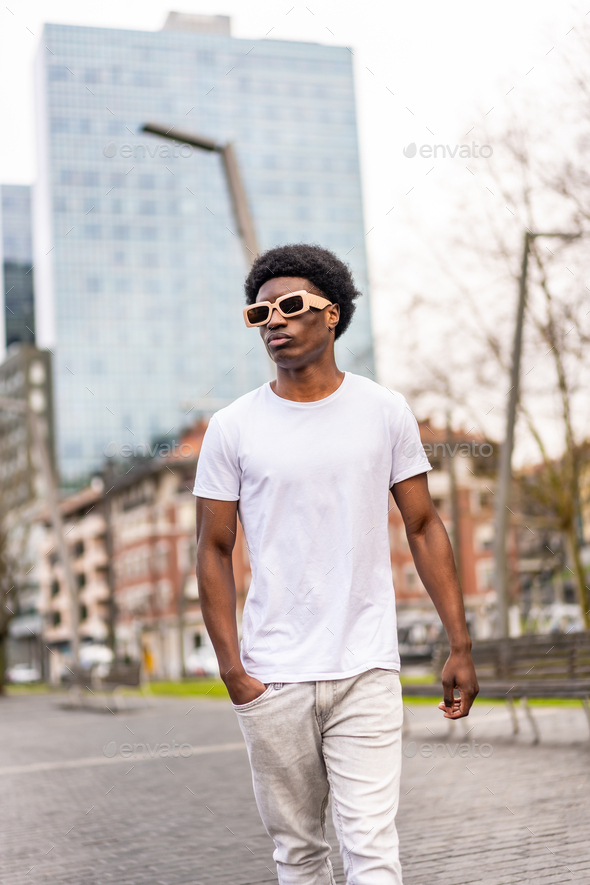 Cool and casual stylish african man walking along a city Stock Photo by ...