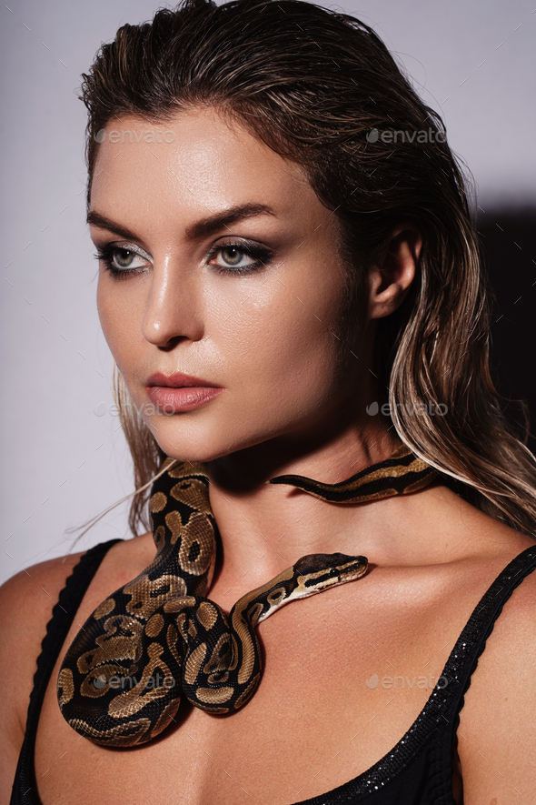 Stunning nude woman with python snake elegantly slithering over her ...