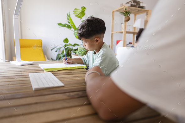 Focused Boy Studying Hard at Home Stock Photo by josecarloscerdeno