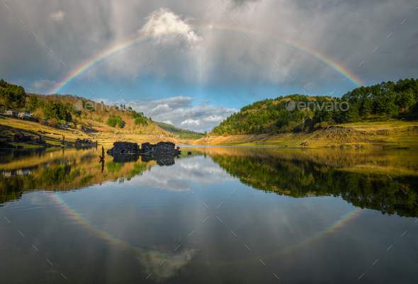 A complete rainbow and its reflection in the river Stock Photo by ...