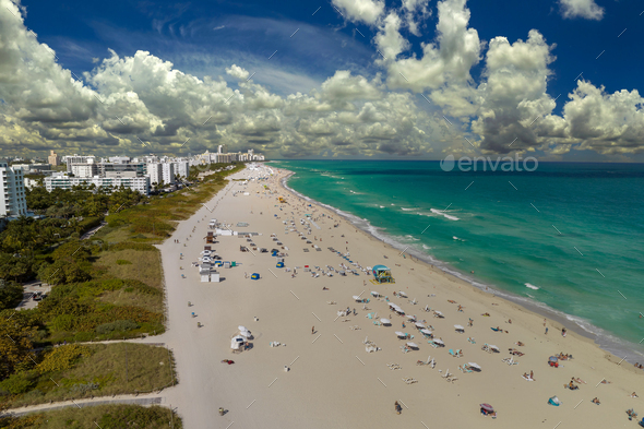 South Beach sandy surface with tourists relaxing on hot Florida sun ...