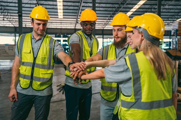 factory setting, team of engineers and foremen emphasize safety and ...