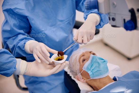 Close up of surgeon using iodine for sterilization in operating room at ...